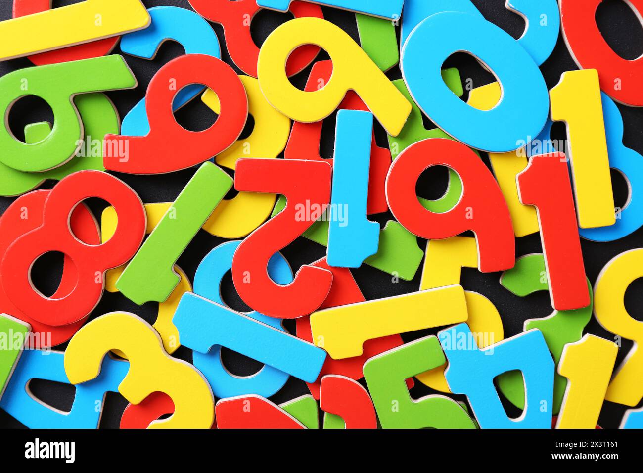 Colorful numbers on black background, top view Stock Photo - Alamy