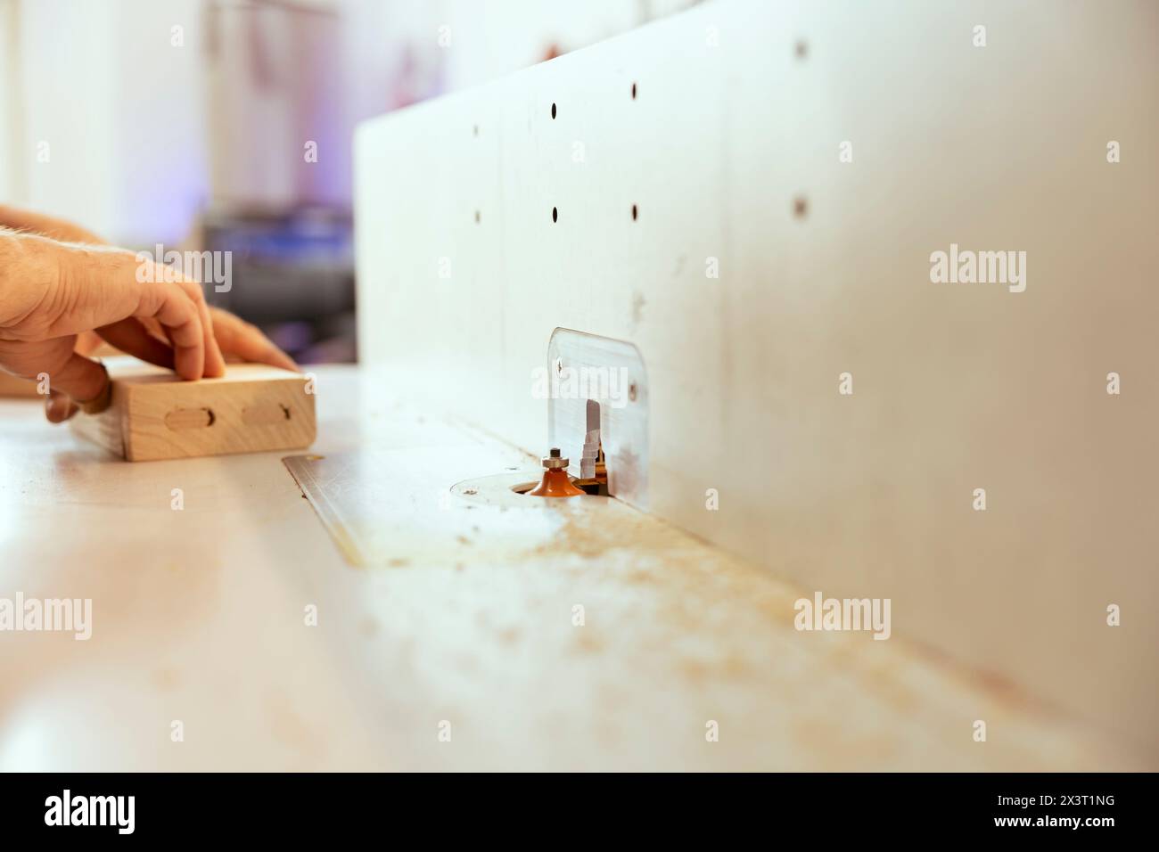 Carpenter using wood shaper machinery to finish client commissioned ...