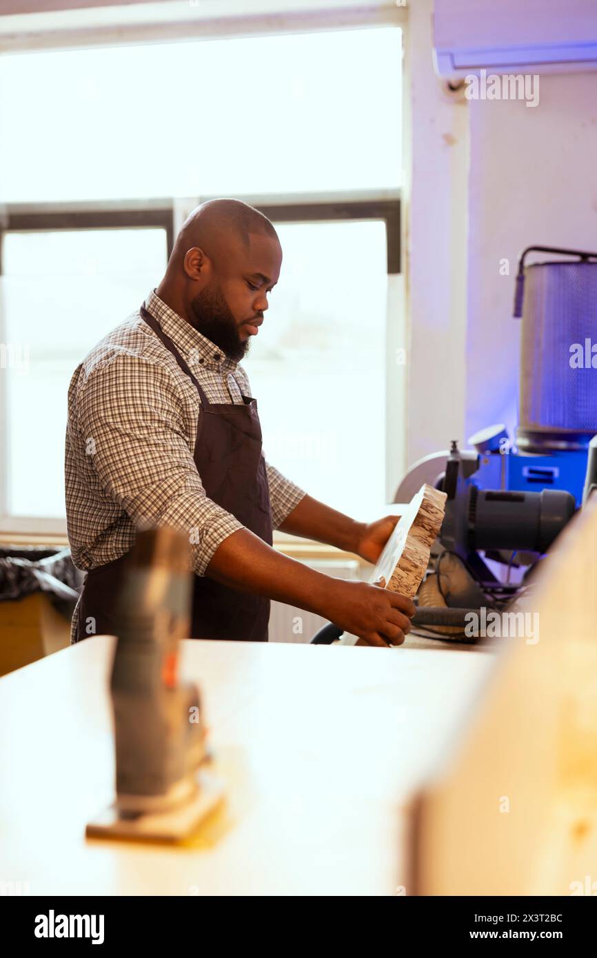 Carpenter selecting high quality wood materials, ensuring they align ...