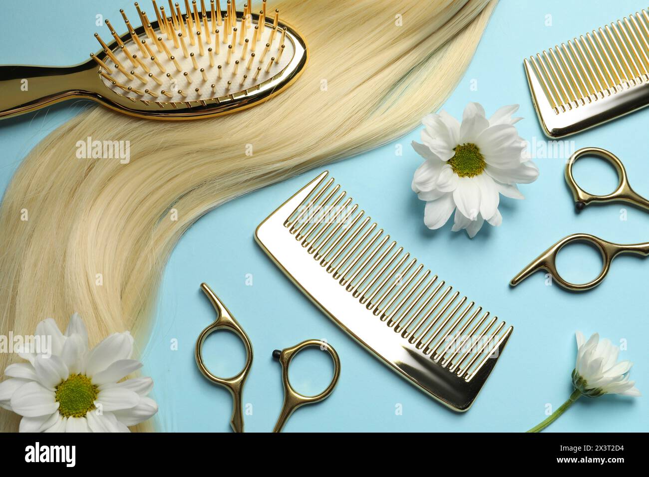 Flat lay composition with professional hairdresser tools, flowers and ...