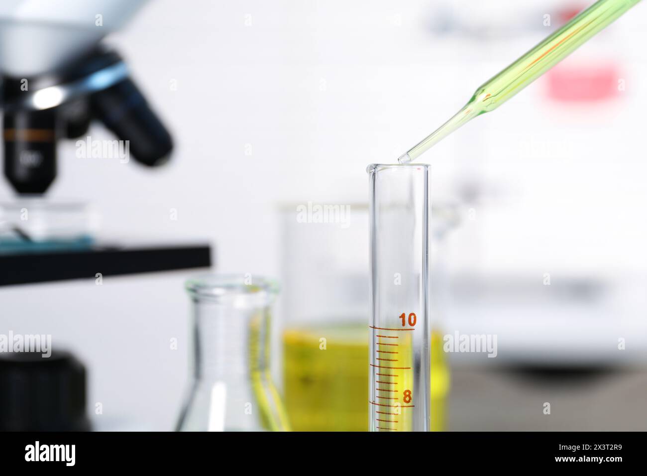 Laboratory analysis. Dripping liquid into test tube on table, closeup ...