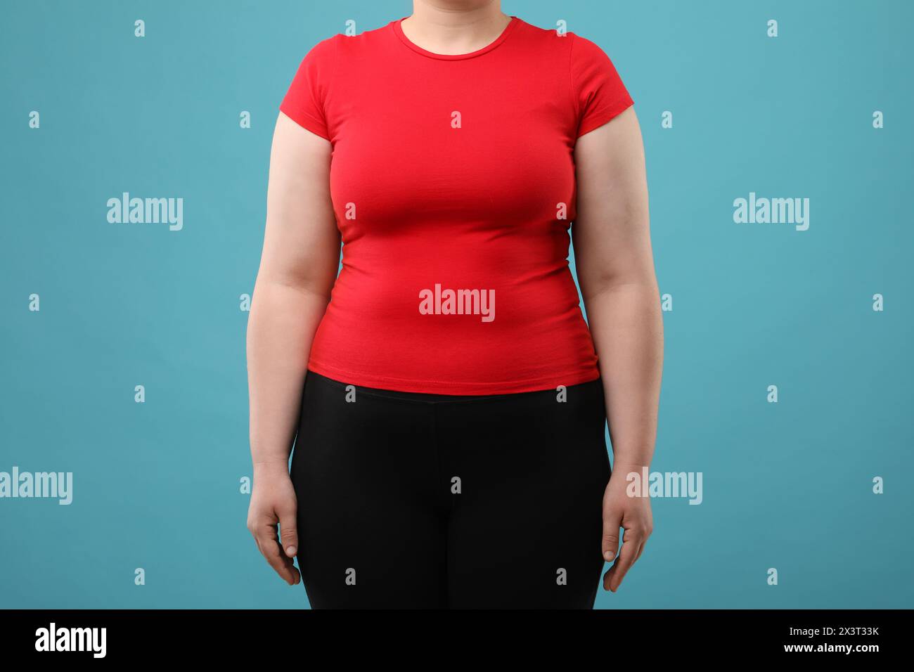 Overweight woman on light blue background, closeup Stock Photo - Alamy