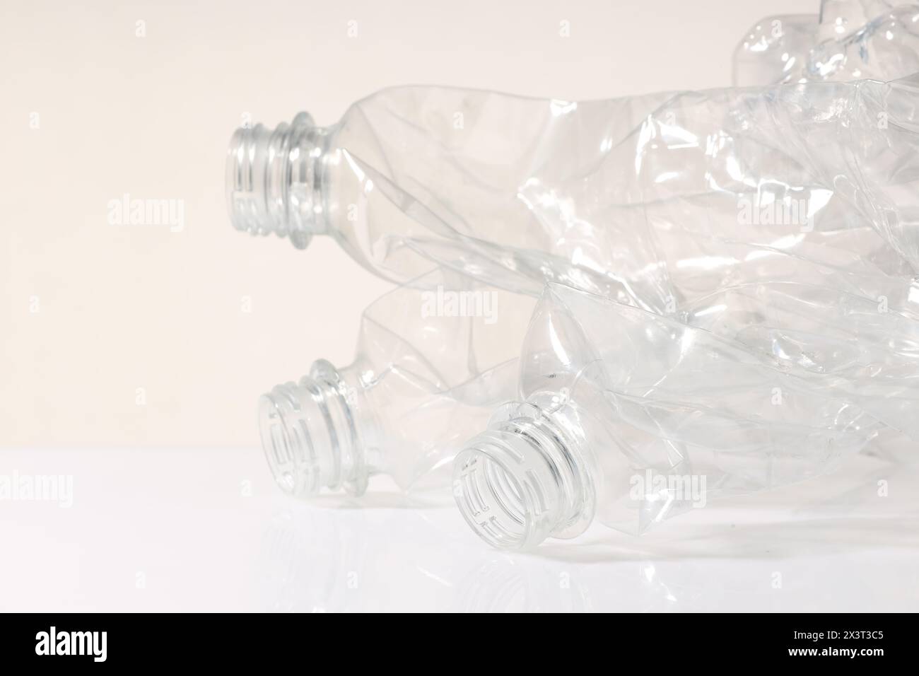 Crumpled disposable plastic bottles on white background Stock Photo - Alamy