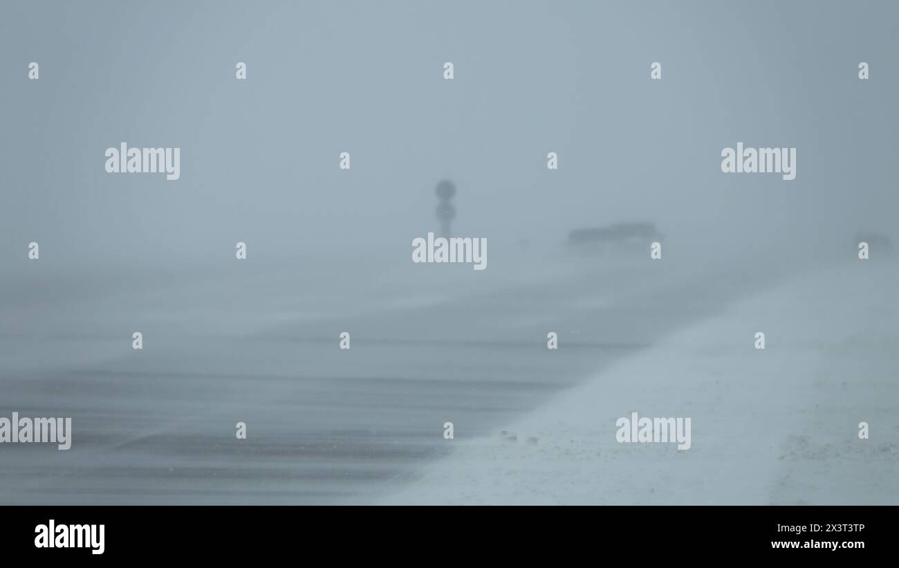 Cars on winter road at blizzard Stock Photo - Alamy