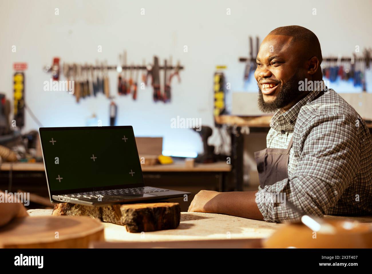 Joyful woodworker and BIPOC coworker using CAD software on green screen ...