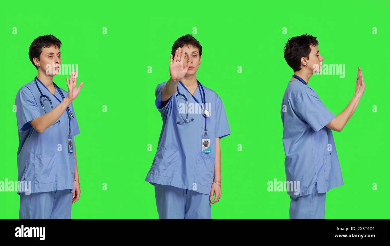 Health specialist with blue scrubs showing stop sign in studio ...