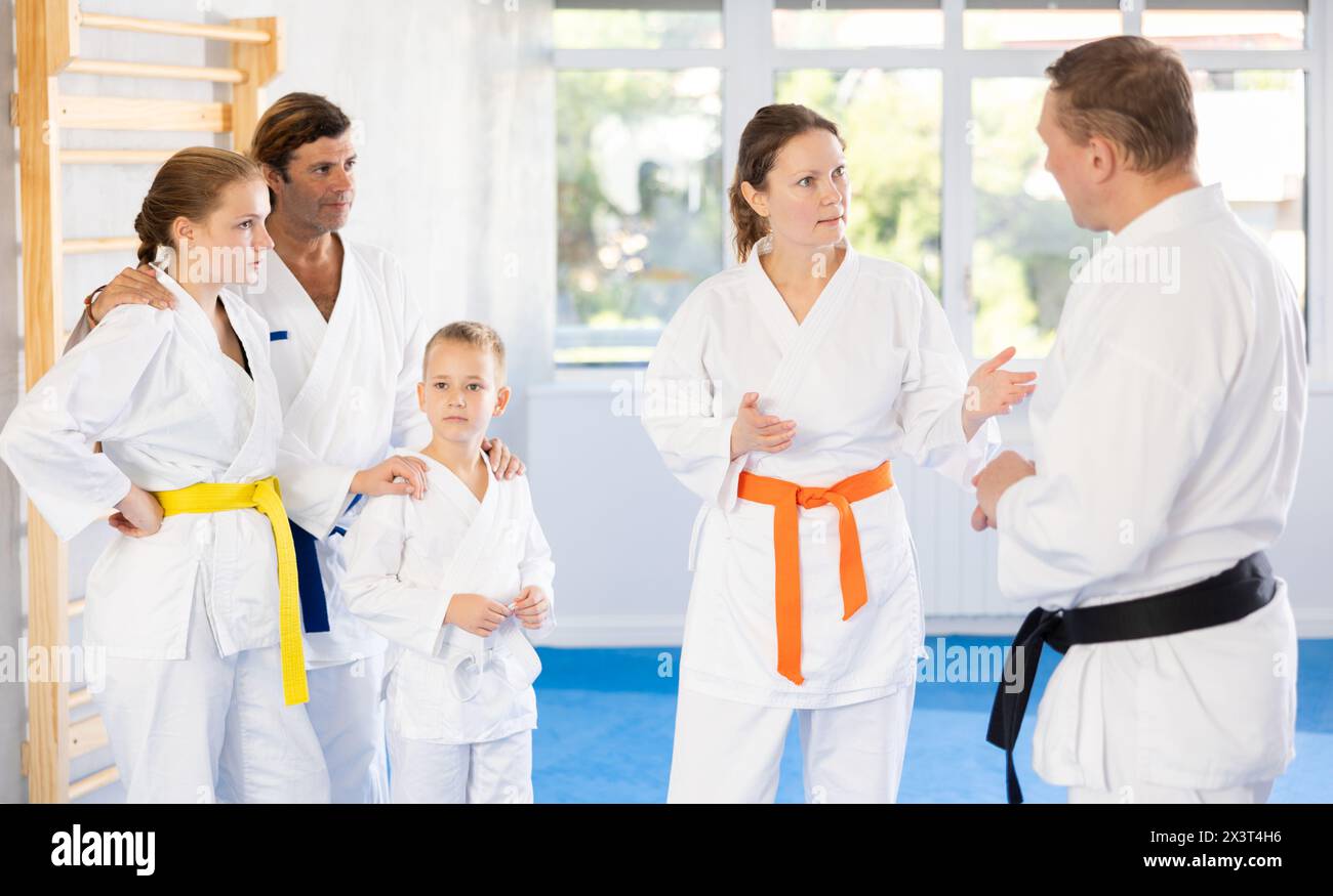 After completing family session and karate training, parents talk with ...