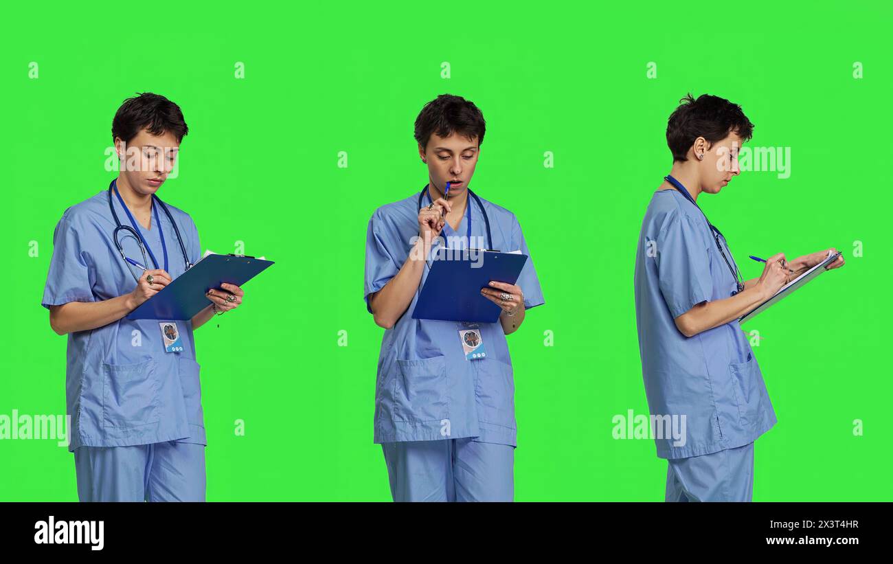 Medical assistant writing checkup information on clipboard files ...