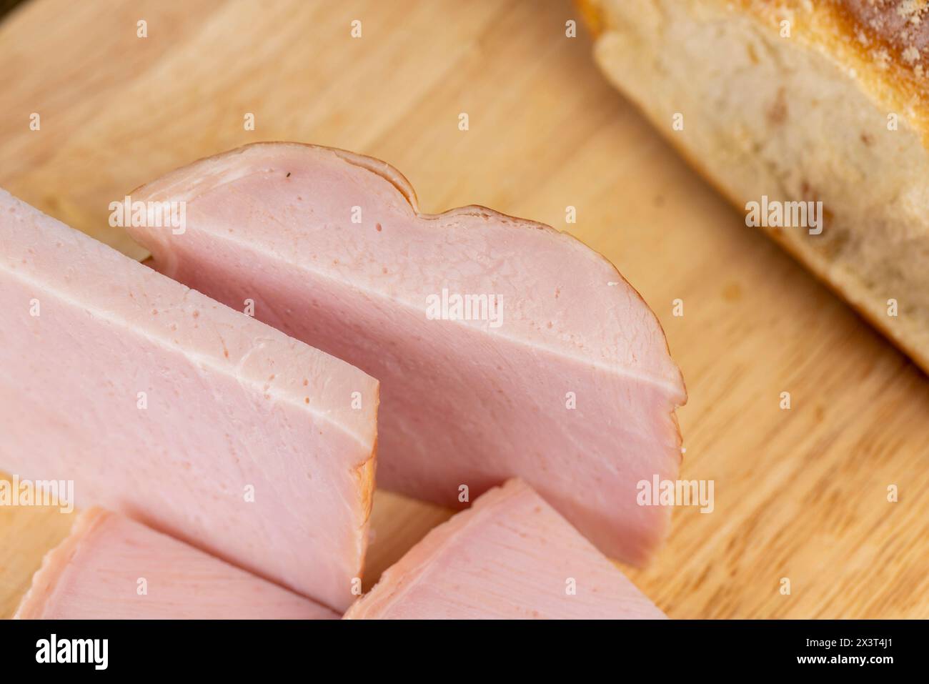 sliced piece of pork ham, slicing a finished piece of ham into small ...