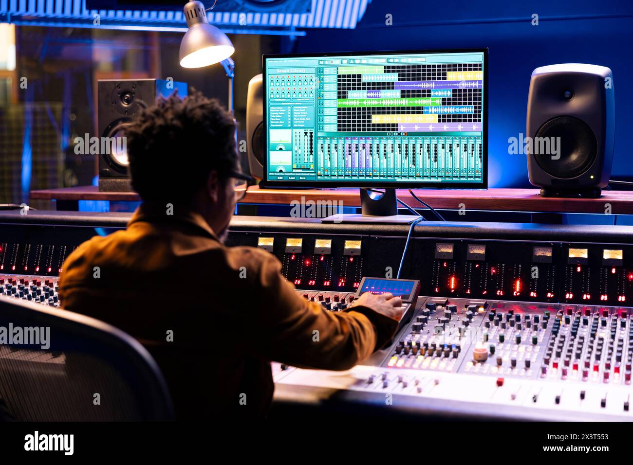 African american audio expert operating editing software to adjust ...