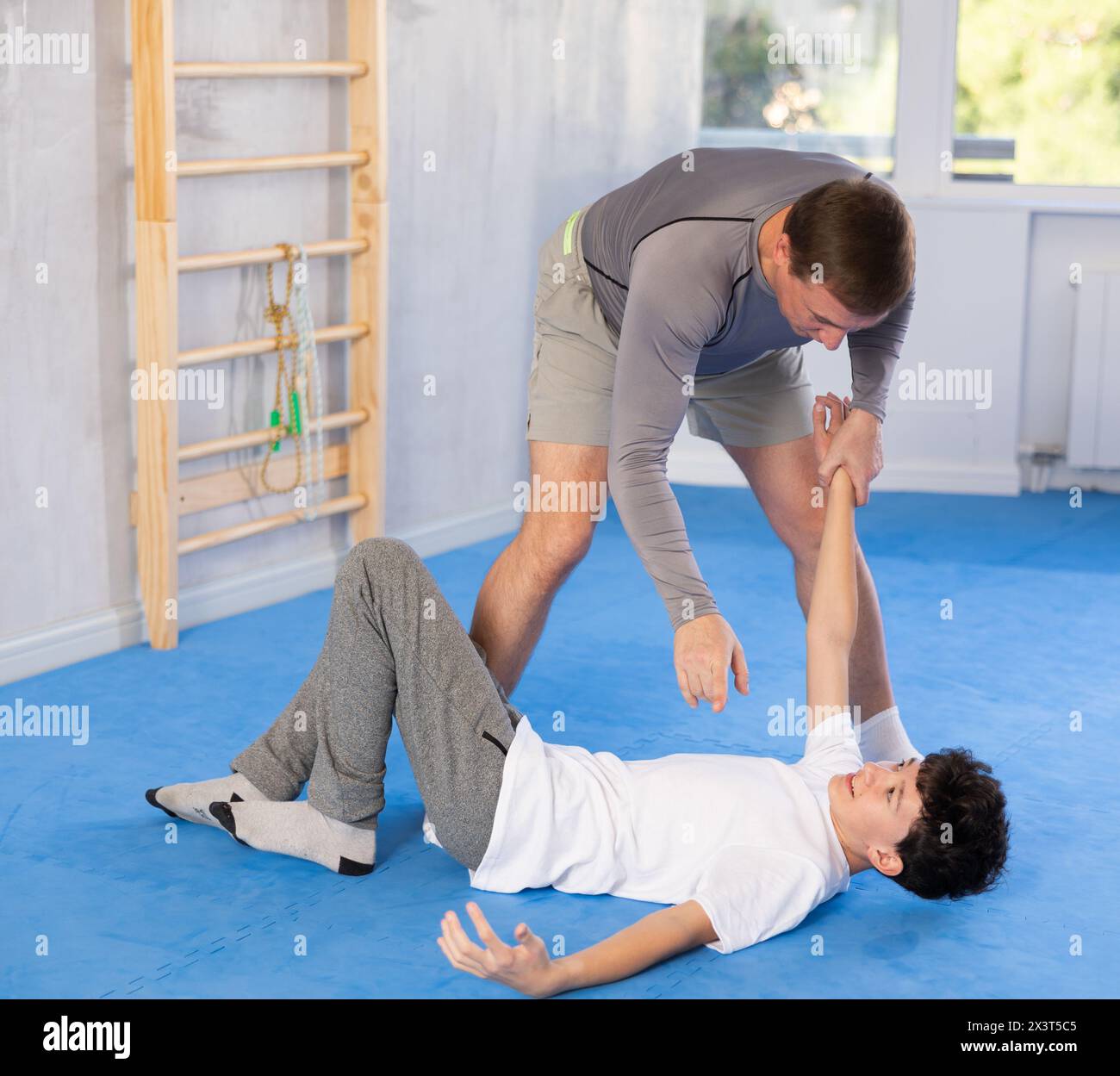 Man and boy teenager training self-defense techniques Stock Photo - Alamy