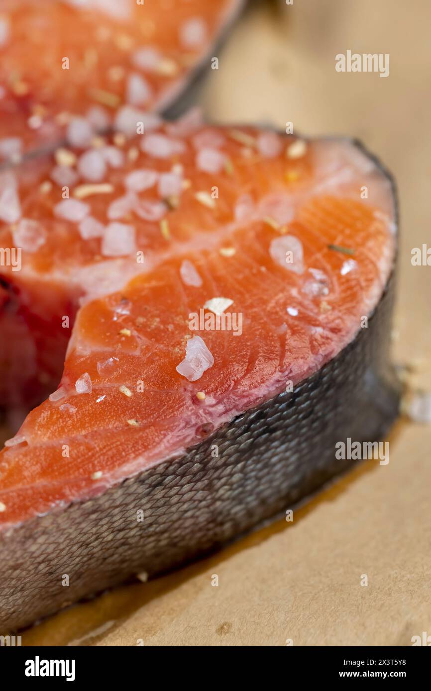 red trout meat in the kitchen, cooking a fish dish with expensive red ...
