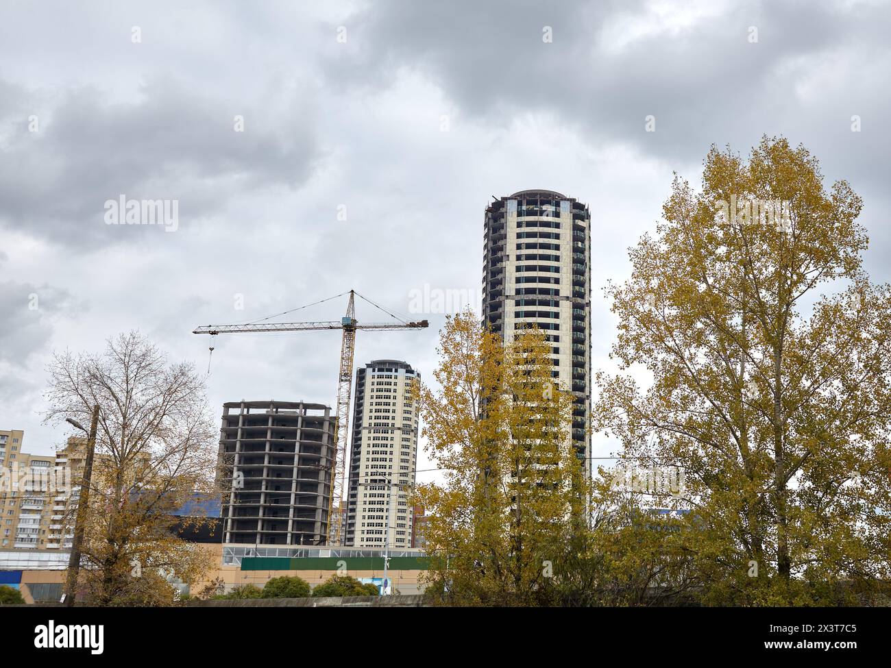 Tower crane building a house. Concrete building under construction ...