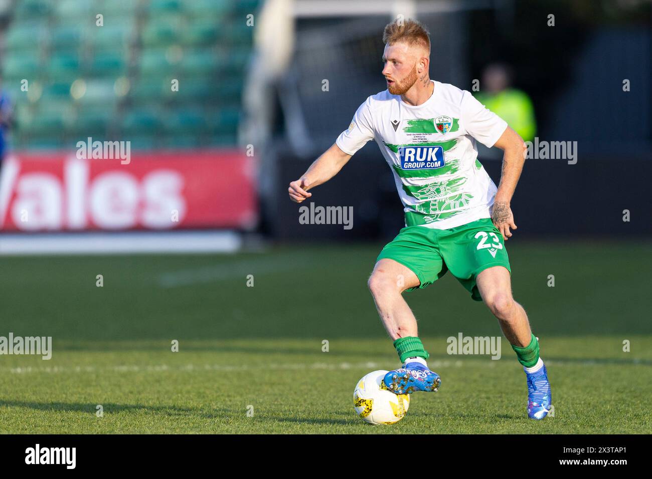 Newport, UK. 28th Apr, 2024. Brad Young of TNS in action. Connahs Quay ...