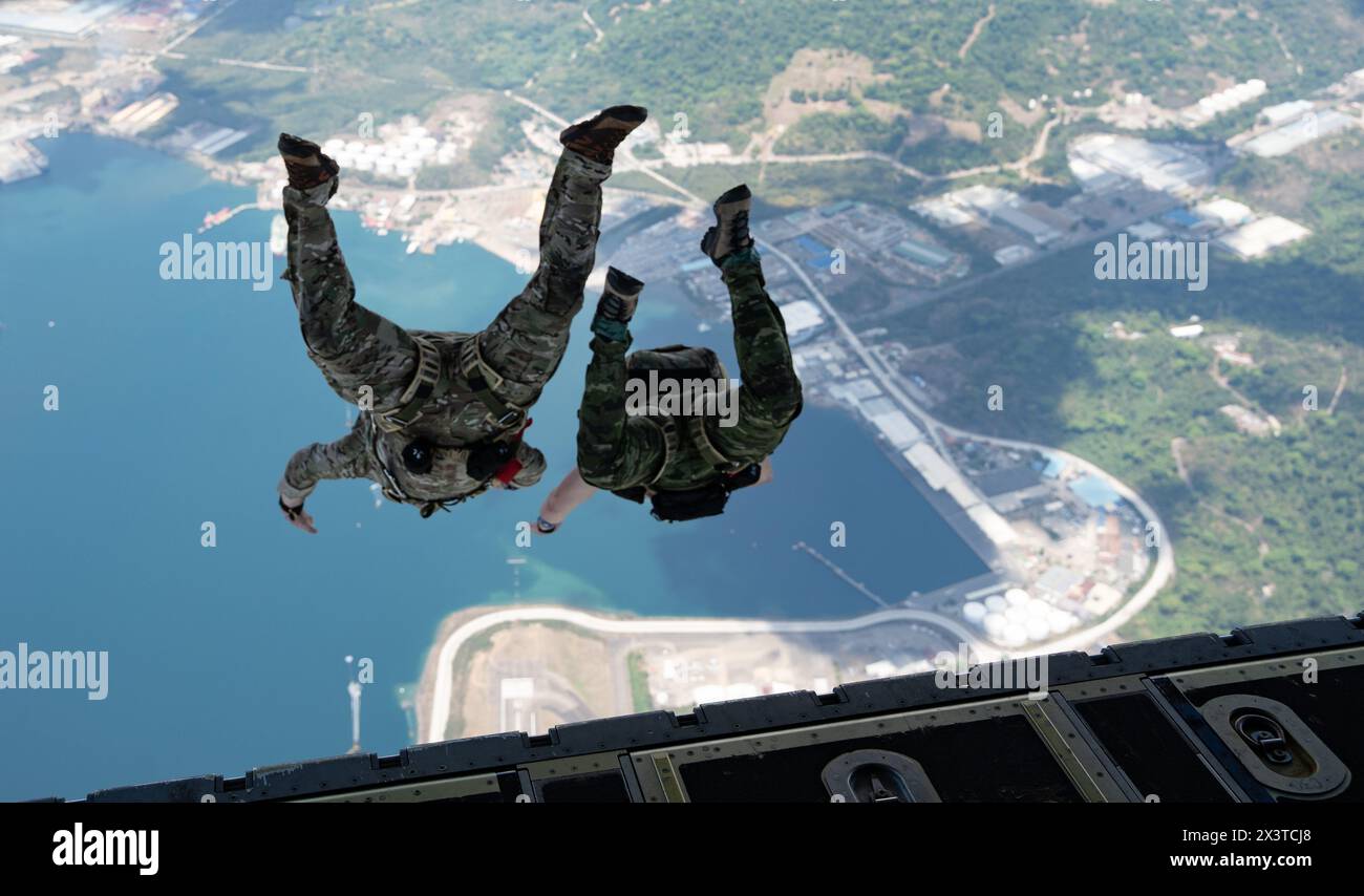 Two Armed Forces of the Philippines members leap out from an MC-130J ...