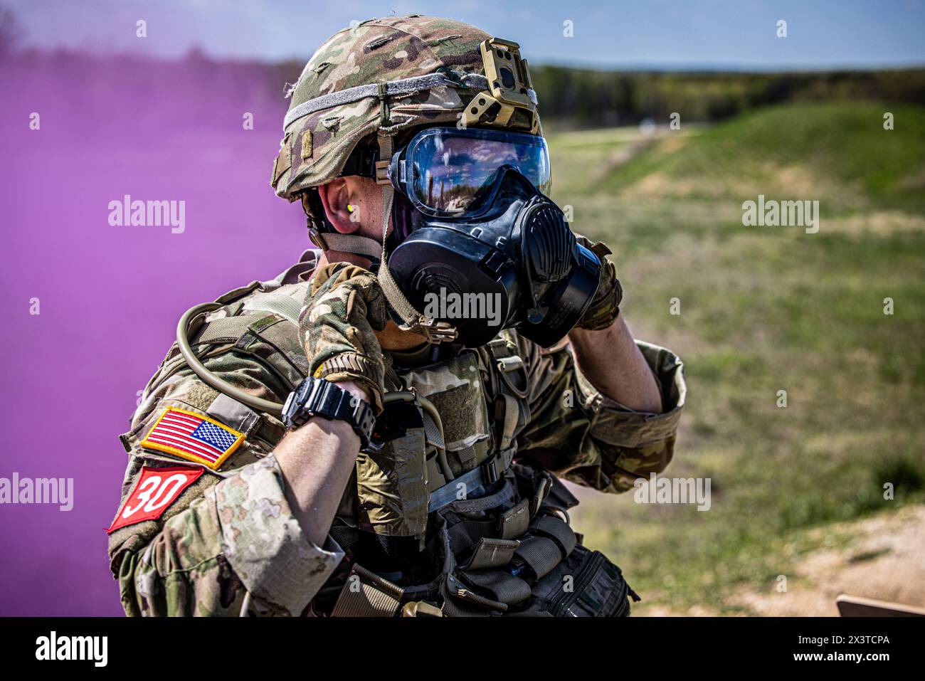 U.S. Army Soldier dawns his protective mask before engaging targets ...
