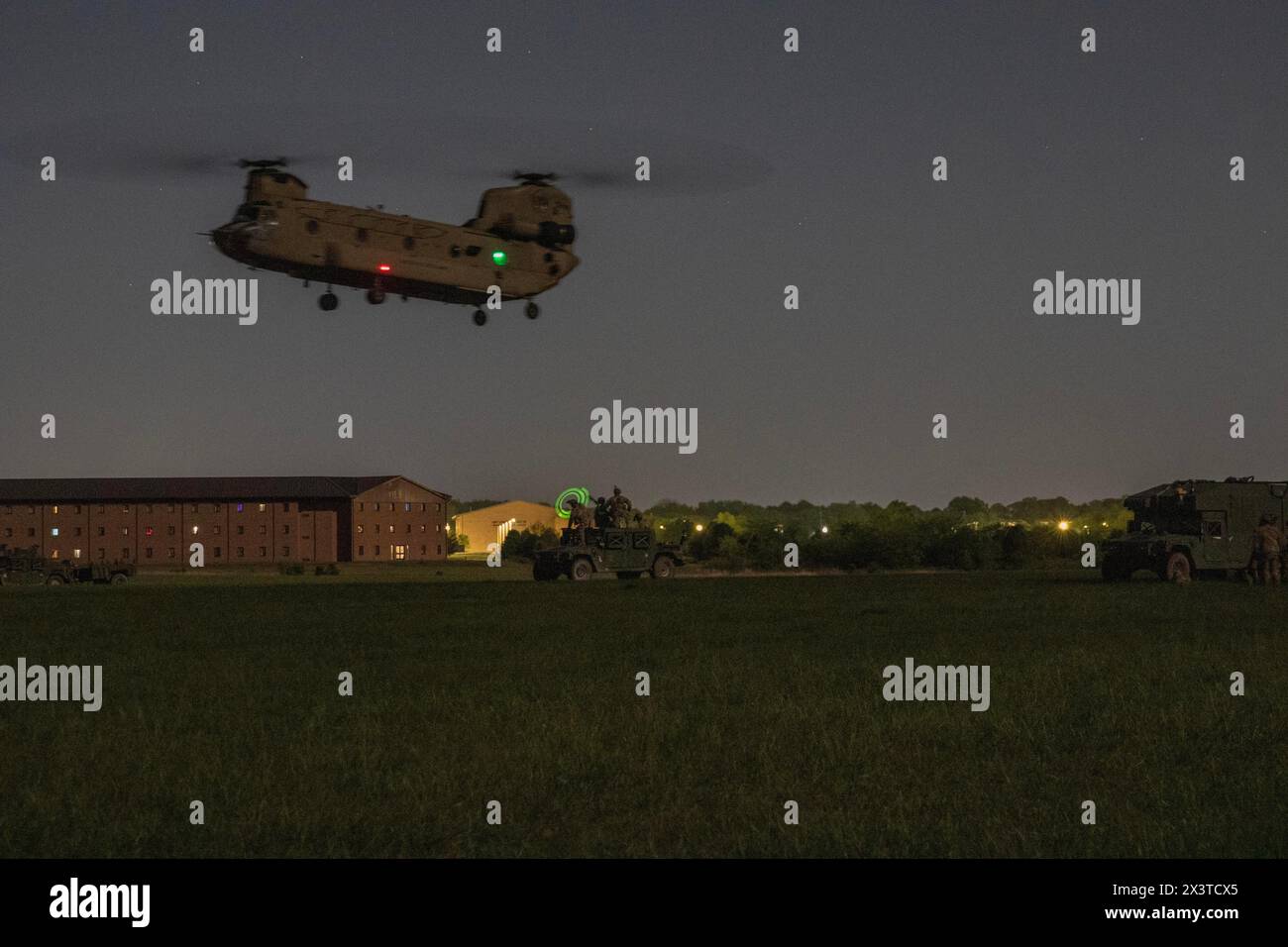 Soldiers from the 101st Airborne Division (Air Assault) signal a CH-47 ...