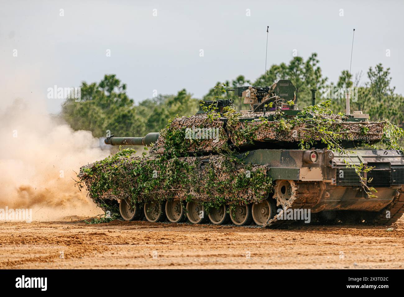 An Abrams tank fires on a simulated enemy position on Red Cloud Range ...