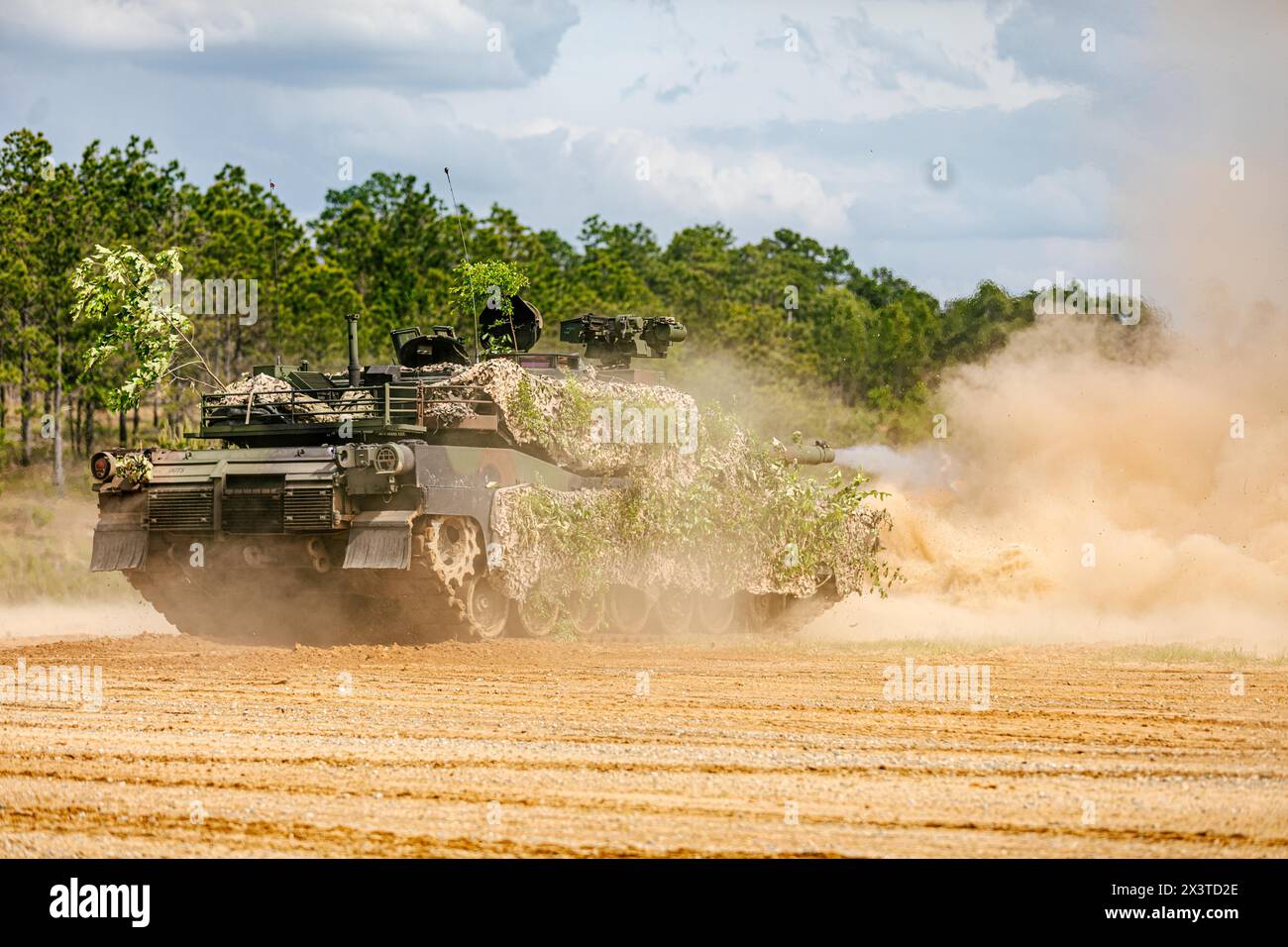 An Abrams tank fires on a simulated enemy position on Red Cloud Range ...