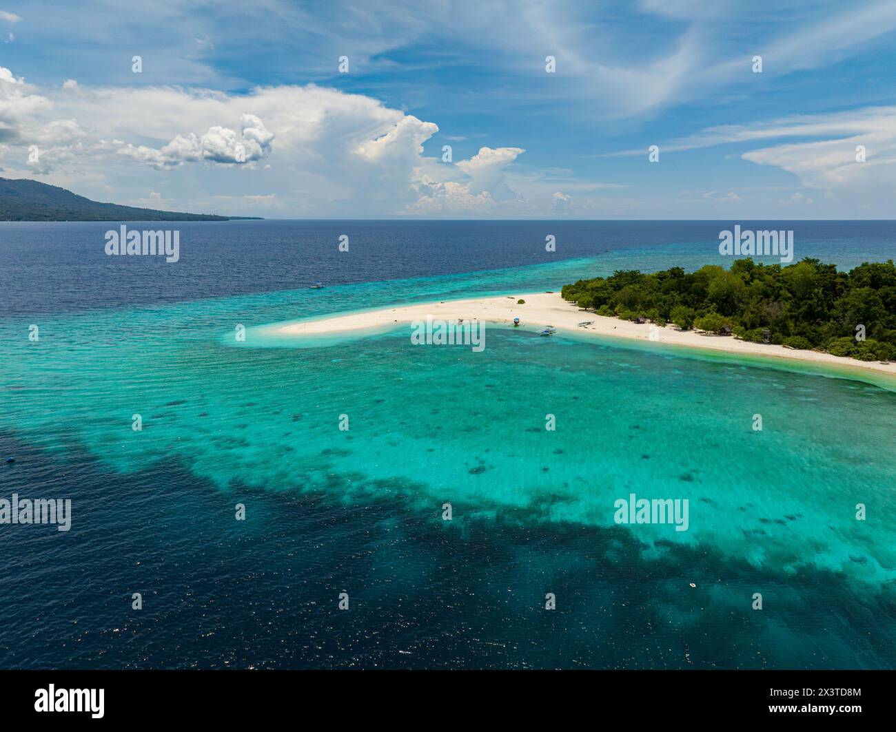 White sand beach in Mantigue Island. Clear turquoise water and blue sky ...
