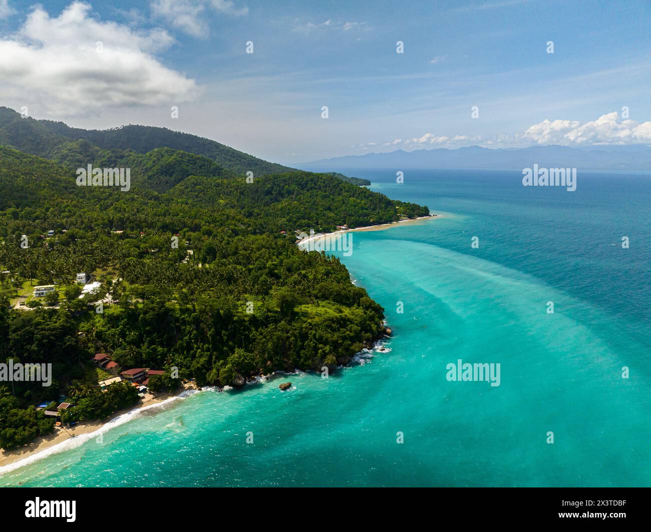 Waves on coastline under blue sky and clouds. Samal Island. Davao ...