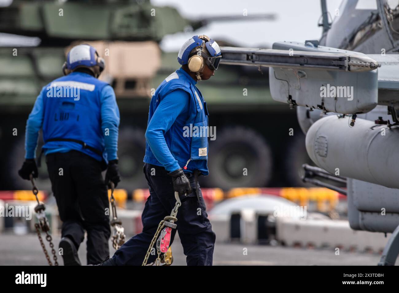U.S. Navy Sailors with the USS Wasp (LHD 1) prepares to chock and chain ...