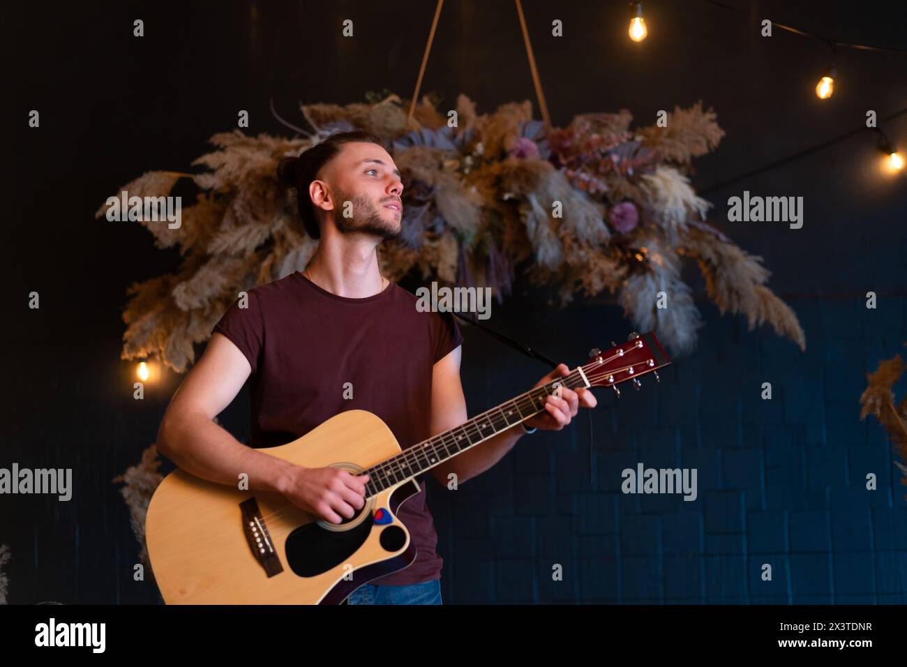 Male musician playing acoustic guitar. Guitarist plays classical guitar ...