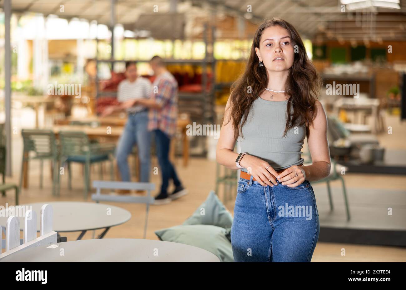 Girl buyer choose table desk in garden furniture store showroom Stock ...