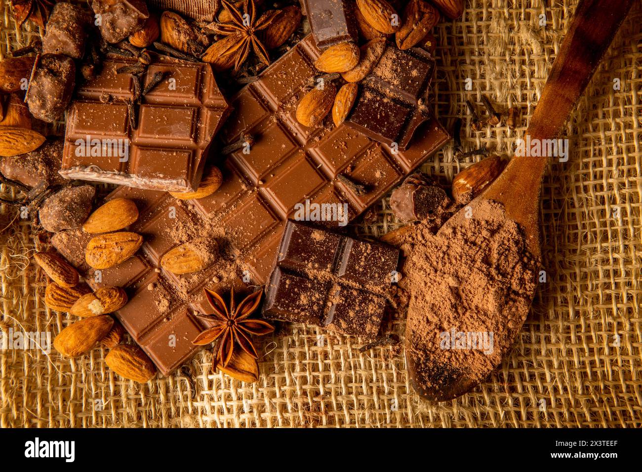Overhead shot of chocolate pieces of different varieties with almonds ...