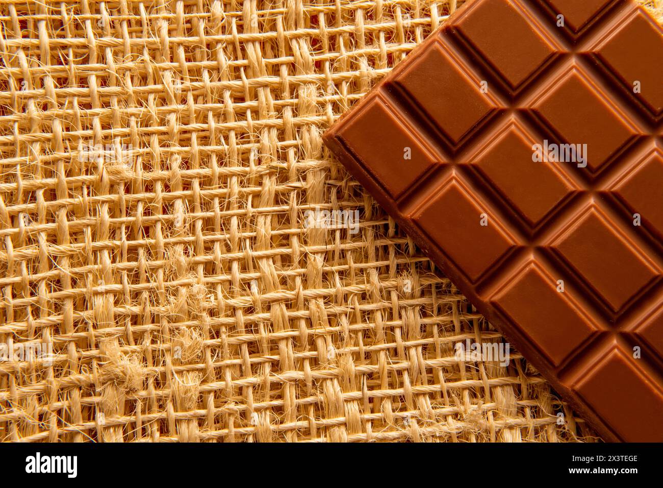 appetizing chocolate bar on an export bag background with copy space ...