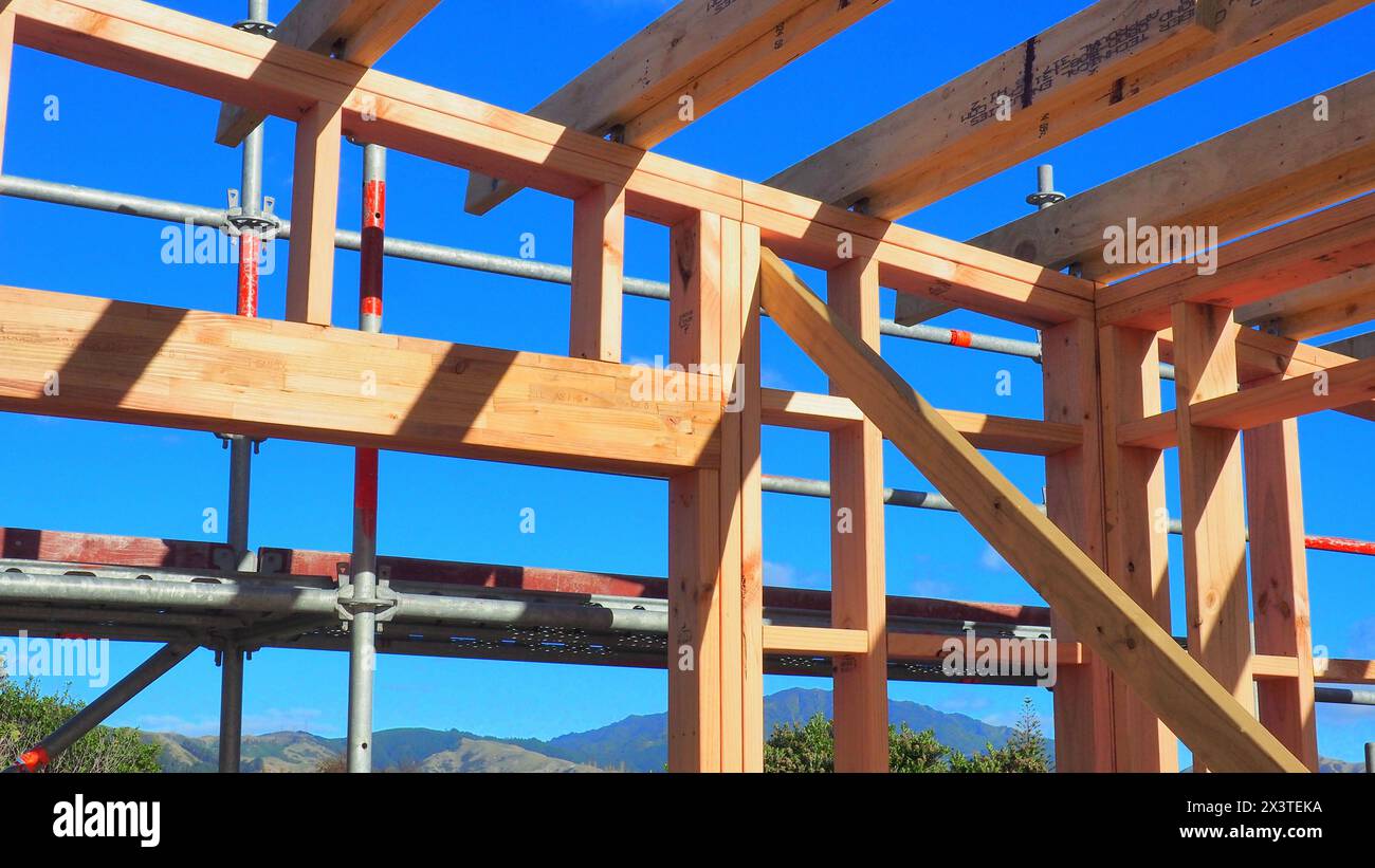 Residential construction with timber framework and scaffolding. Distant ...