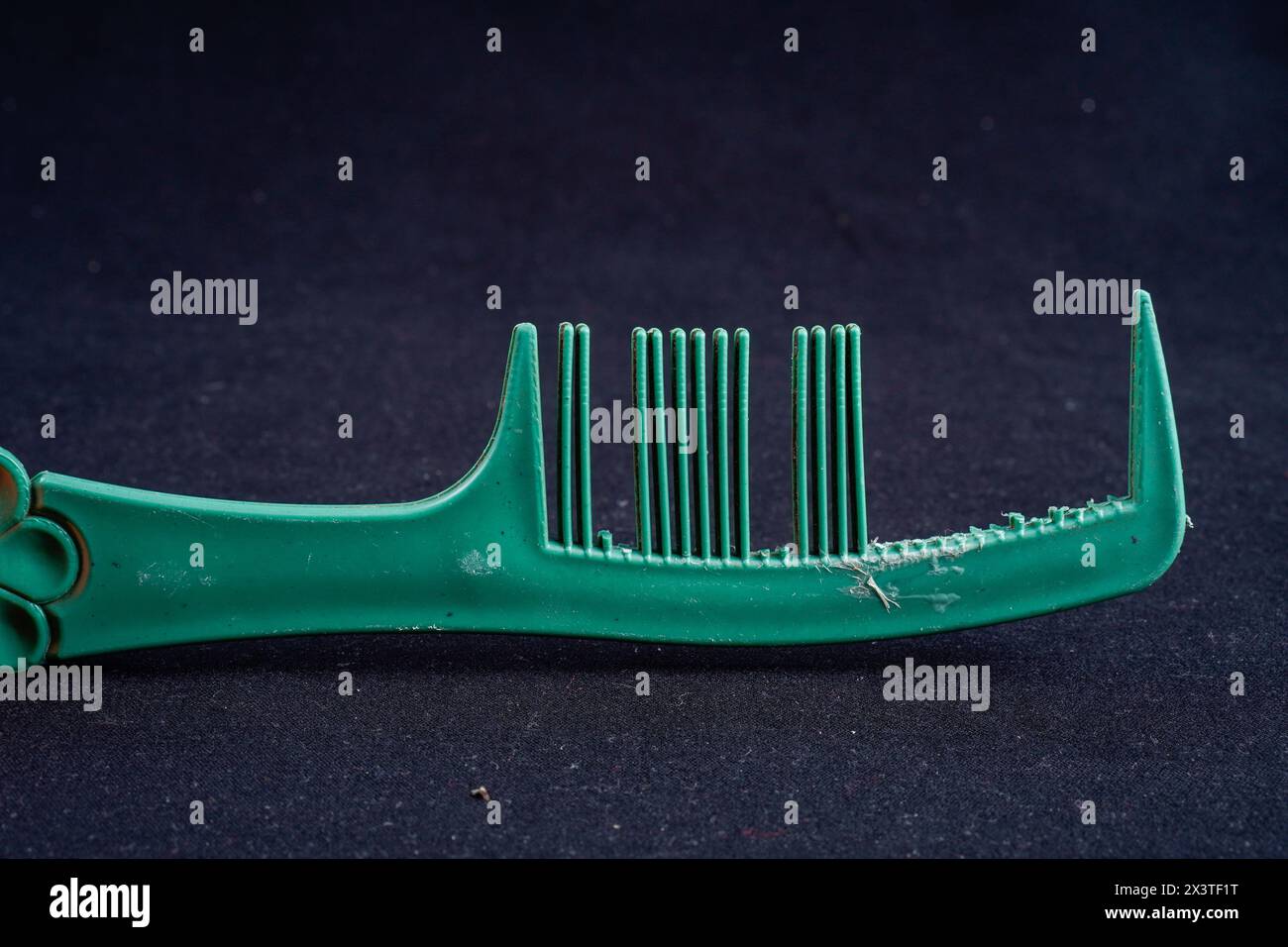 close up of a broken toothed comb on a black background with empty ...