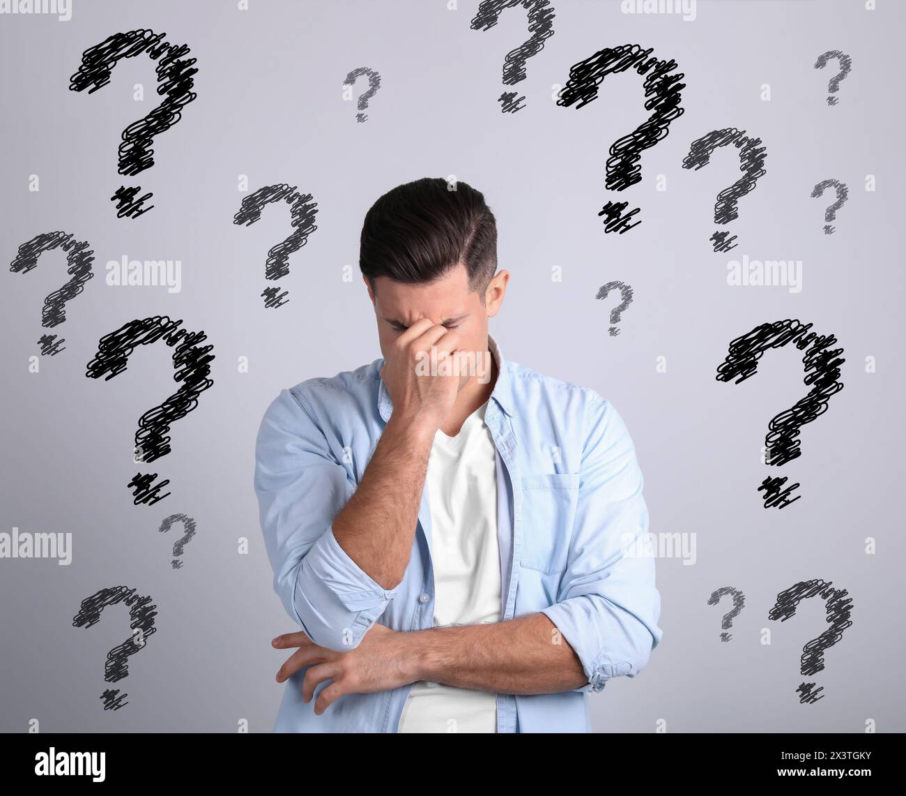 Amnesia. Confused man and question marks on light background Stock ...