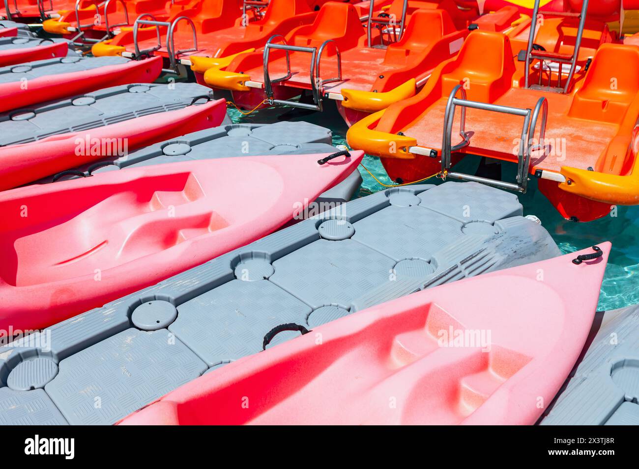 Row of plastic red kayaks on the beach. Water Leisure Boats Stock Photo ...