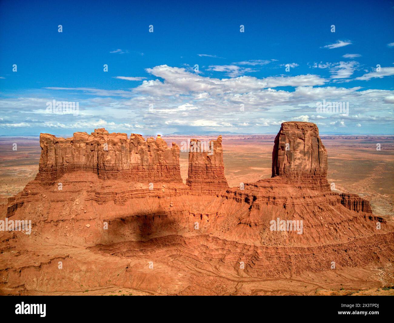 A massive rock formation stands prominently in the desert landscape of ... A massive rock formation stands prominently in the desert landscape of ...