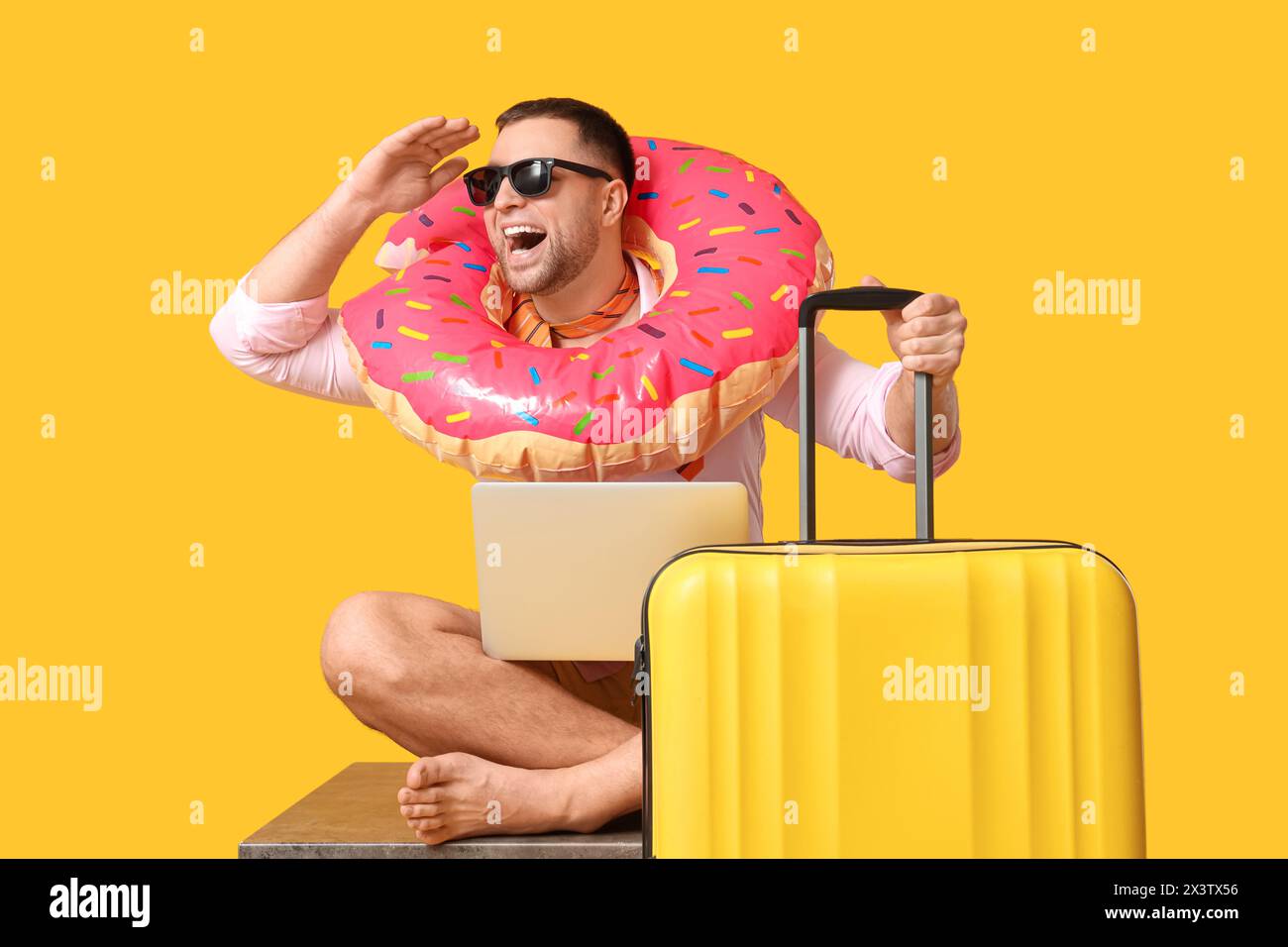 Happy office worker in sunglasses with inflatable ring, laptop and ...