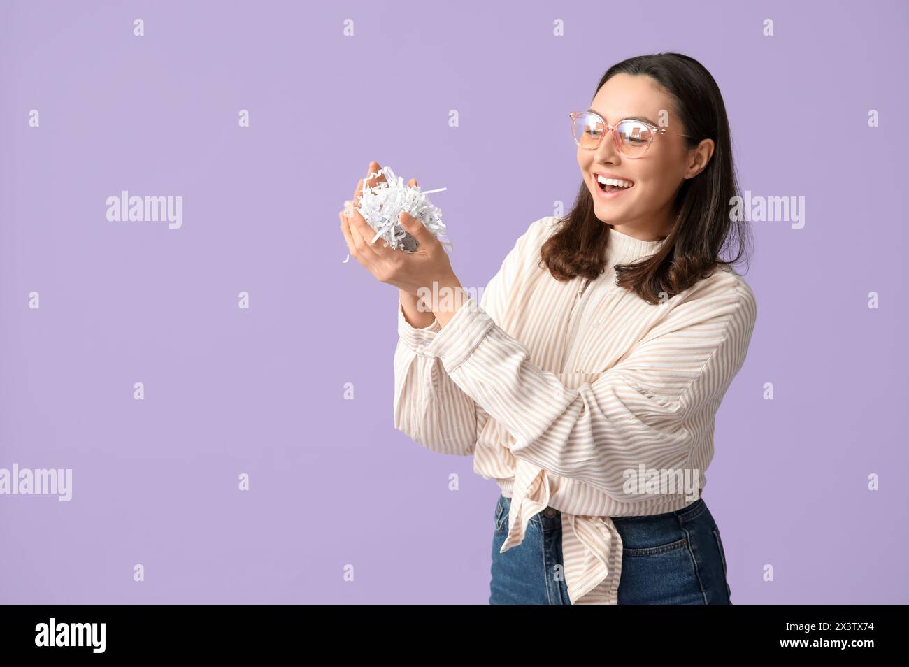 Secretary with shredded paper on lilac background Stock Photo - Alamy