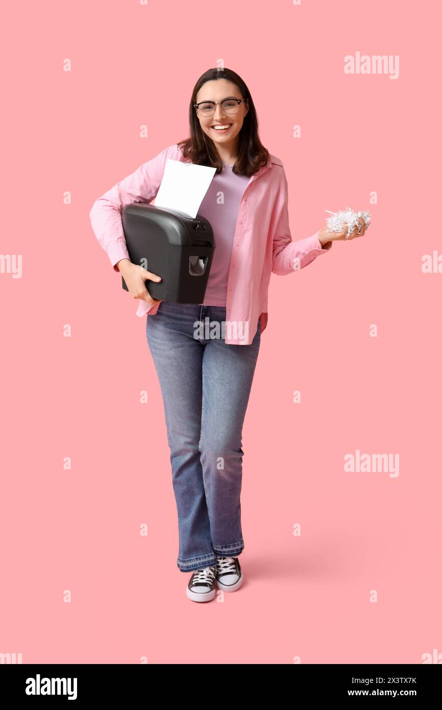 Secretary with shredder on pink background Stock Photo - Alamy