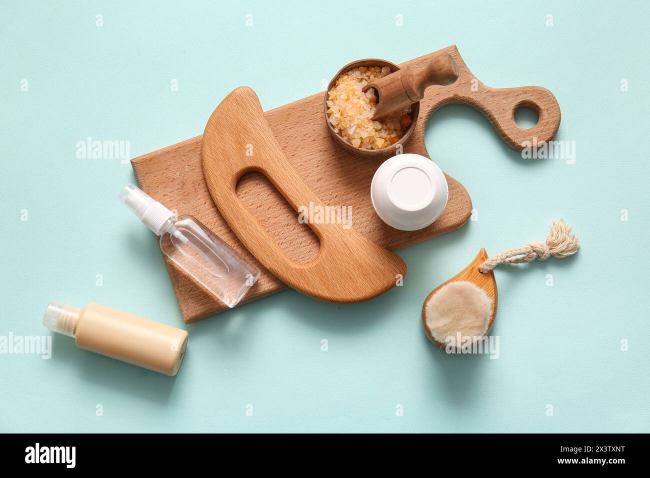 Beautiful spa composition with guasha body scraper on turquoise ...