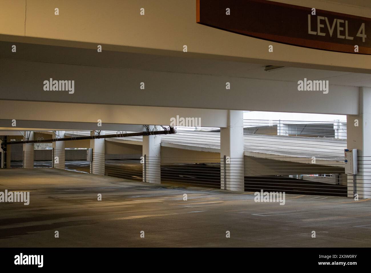 Empty parking garage, ramps to multiple levels, sloped surfaces, mix of ...