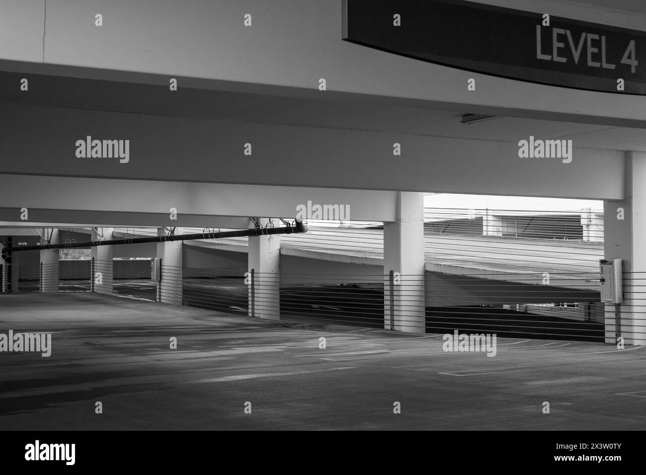 Empty parking garage, ramps to multiple levels, sloped surfaces, mix of ...