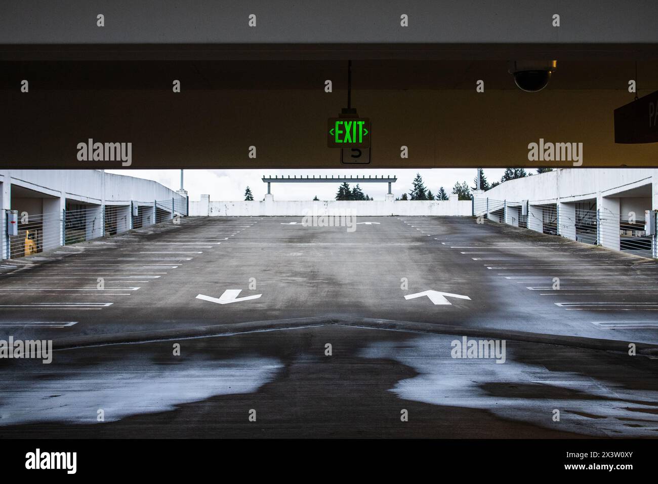 Empty parking garage ramp to rooftop, puddles Stock Photo - Alamy