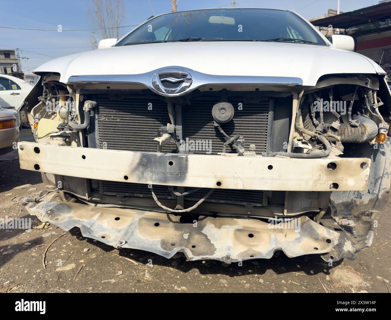 Front bumper of a car removed for maintenance in workshop. Car in ...