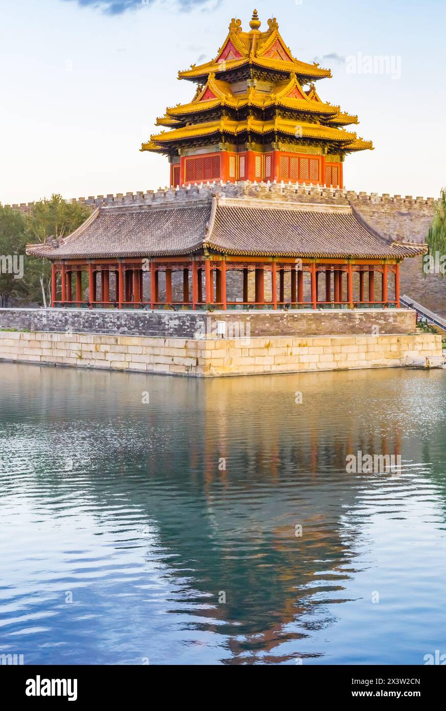 Corner tower reflected in the moat of the Forbidden City in Beijing ...