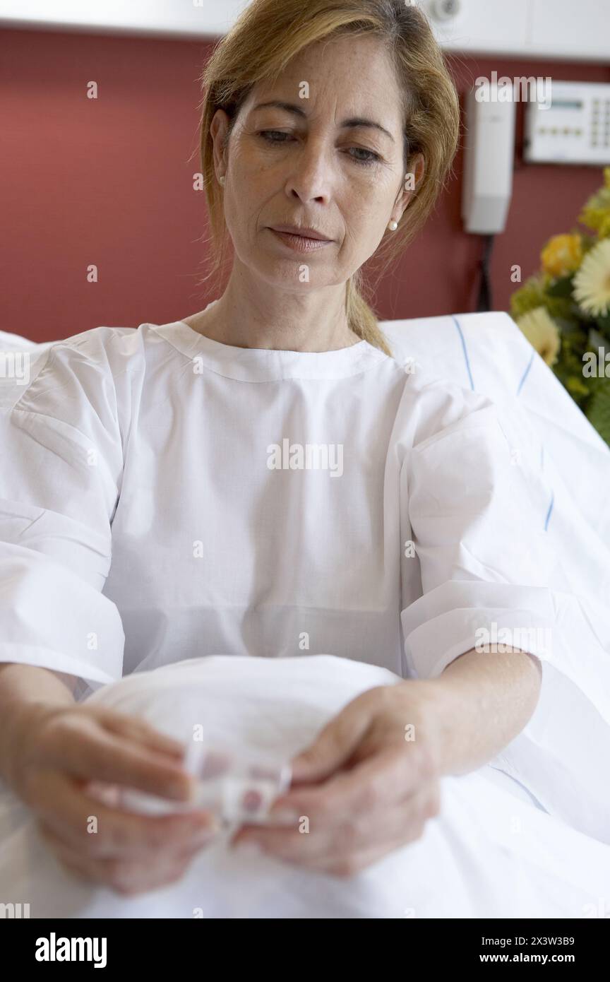 Woman hospital bed pensive hi-res stock photography and images - Alamy