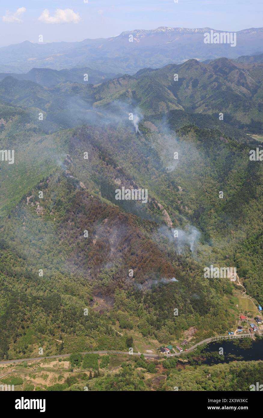 An aerial photo shows a forest fire in Takahata Town, Yamagata ...