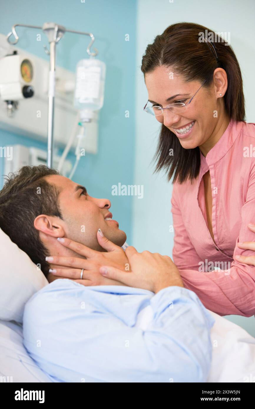 Woman caressing man bed hi-res stock photography and images - Alamy