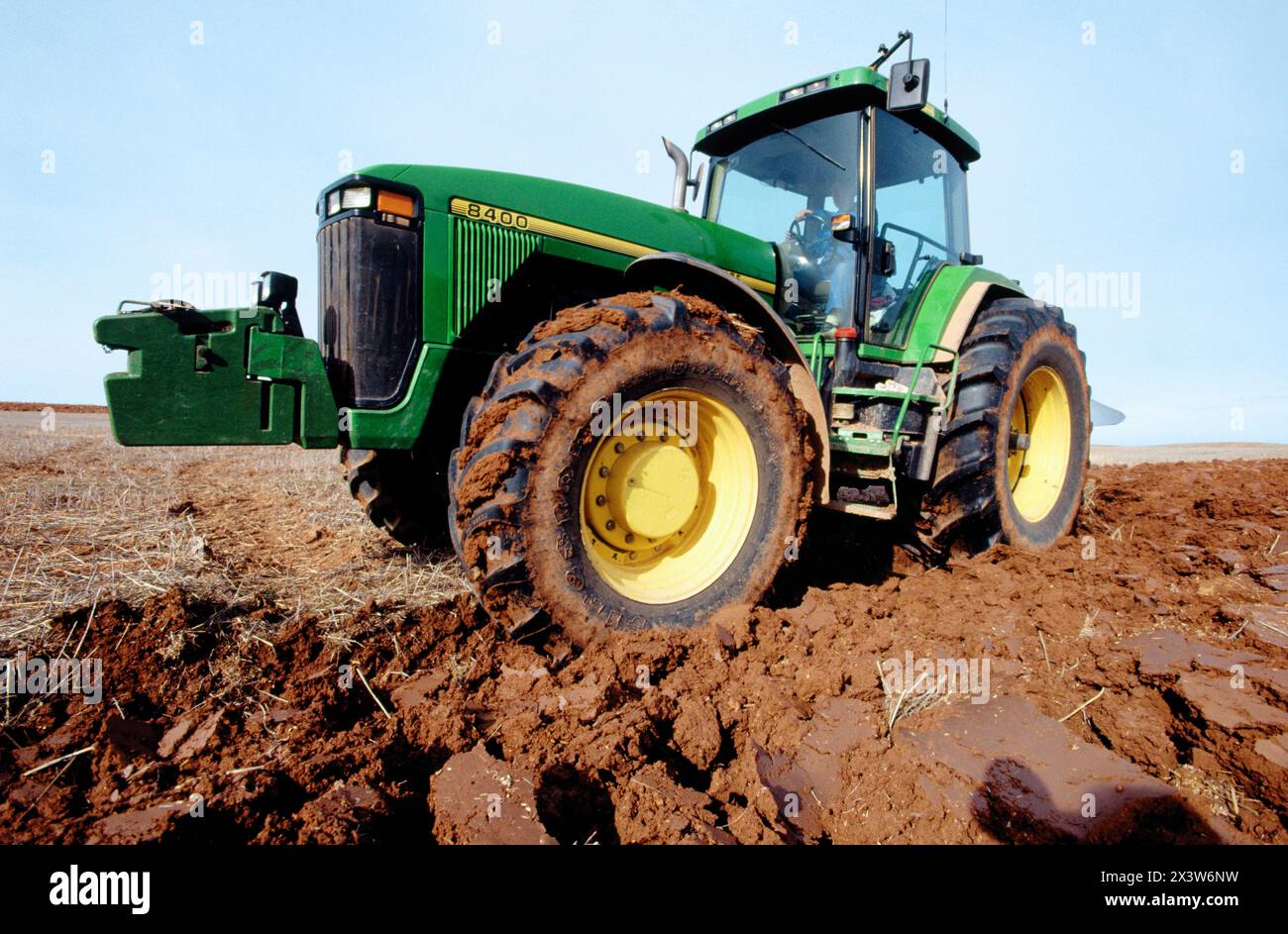 Tractor dragging a plough Stock Photo - Alamy