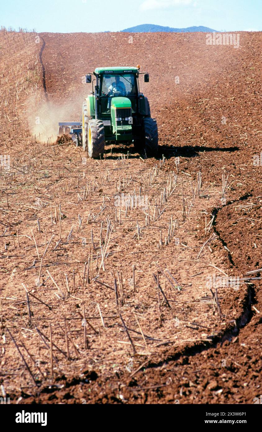Tractor dragging a plough Stock Photo - Alamy