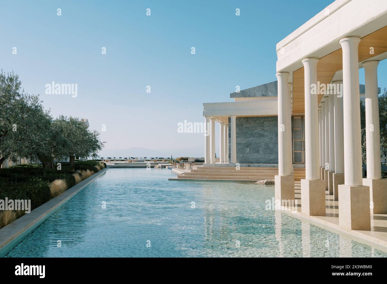 Long pool near a patio with columns. Hotel Amanzoe. Peloponnese, Greece ...